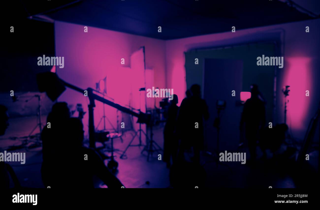 Blurry images of film crew working and filming in video production ...