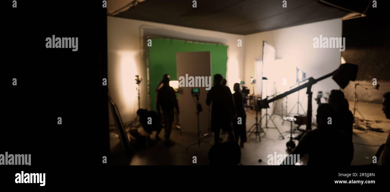 Blurry images of film crew working and filming in video production ...
