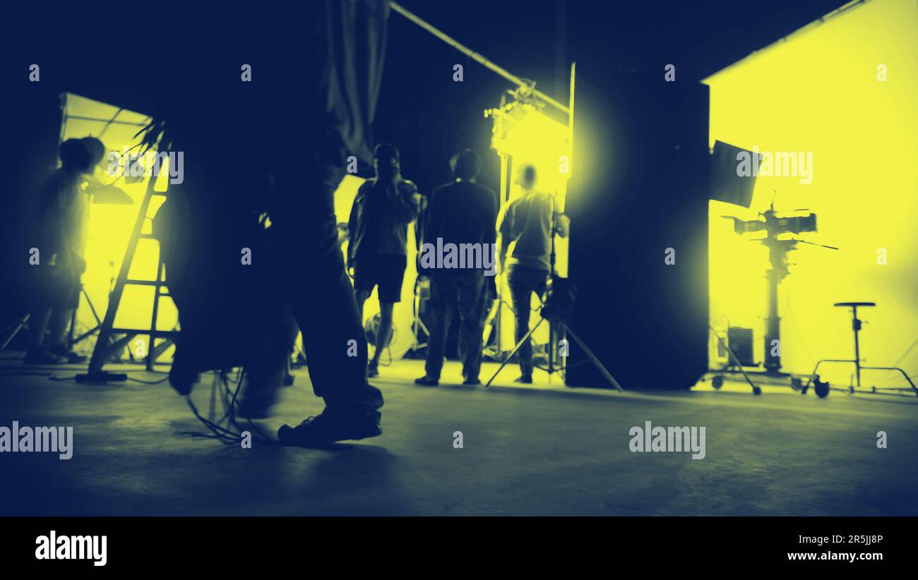Blurry images of film crew working and filming in video production ...