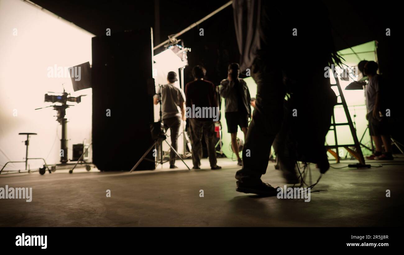 Blurry images of film crew working and filming in video production ...