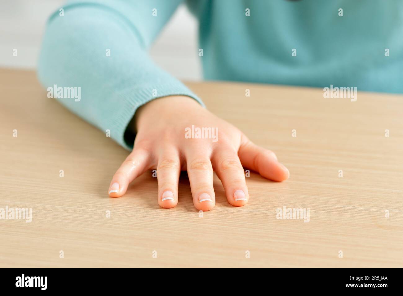 Closeup of a woman sitting and slapping on the table at bank Stock ...