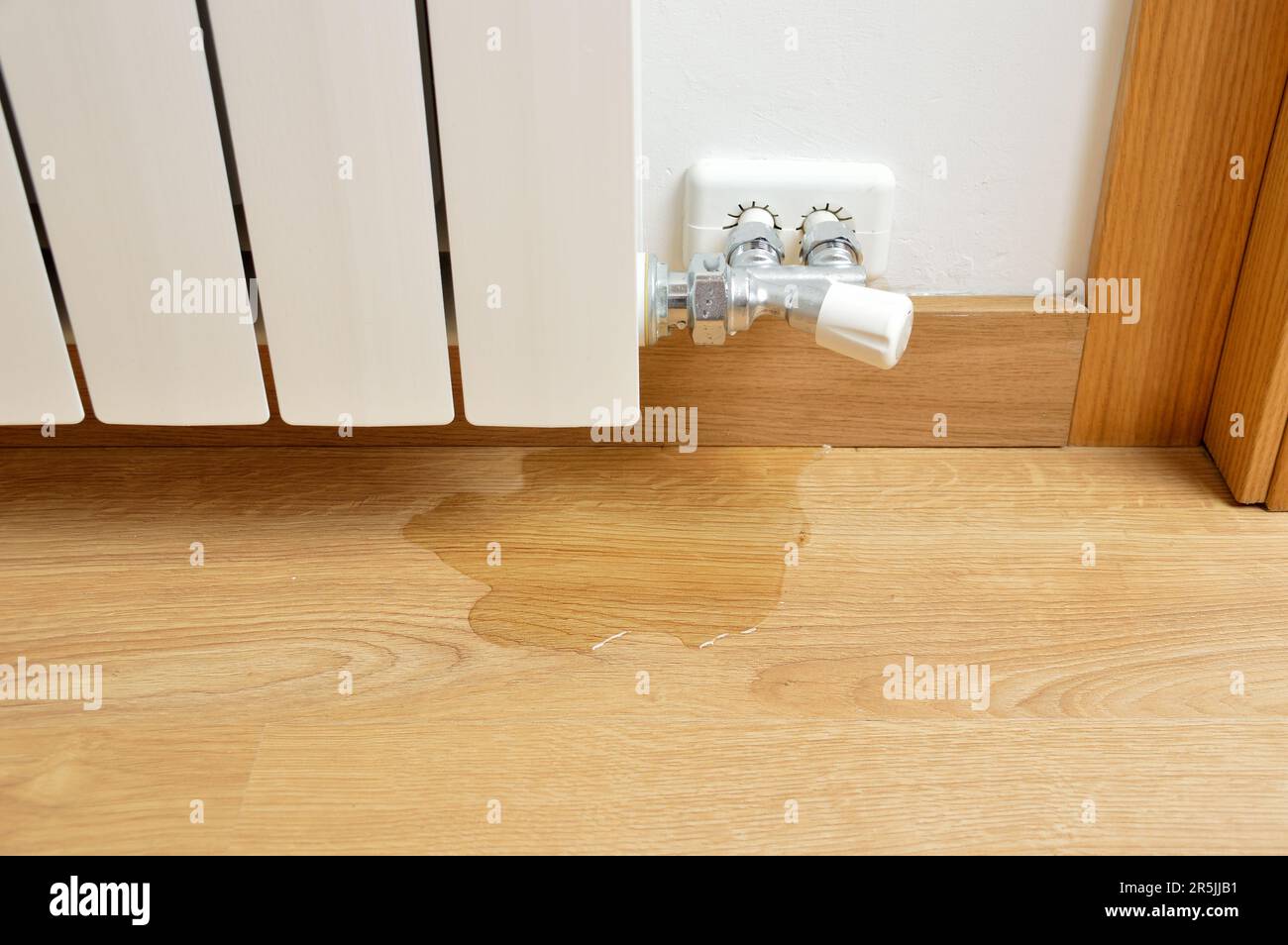 water leak through the heating radiator tube nut Stock Photo - Alamy