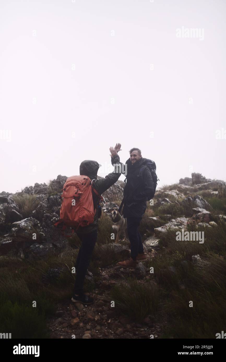 Pushing through is the only way youll make it to the top. two male ...