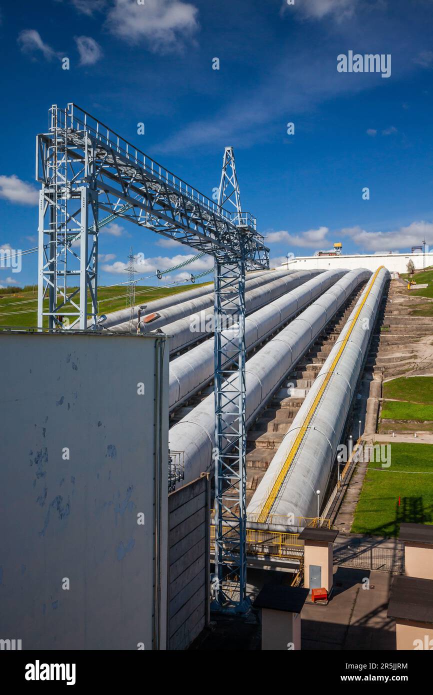 Hydro power plant pipes and electric towers against blue sky Stock ...