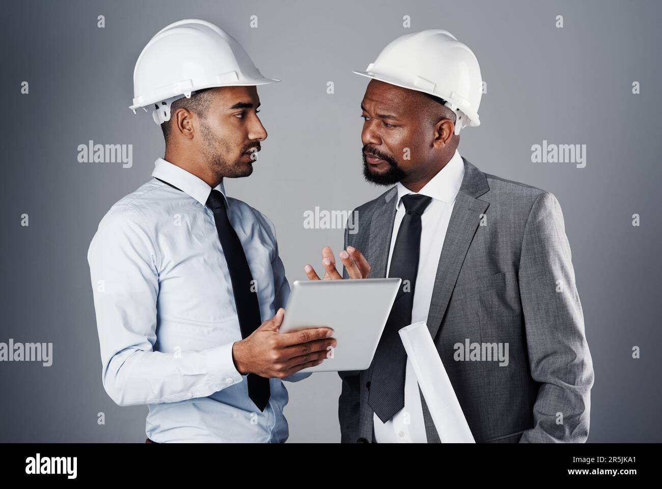 Lets make these plans a reality. two civil engineers discussing ...