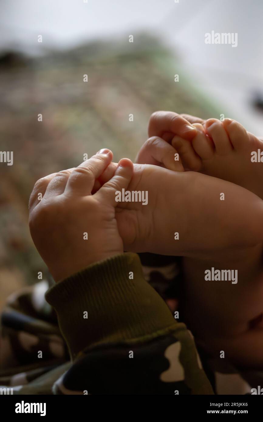 Holding cute baby feet hi-res stock photography and images - Alamy