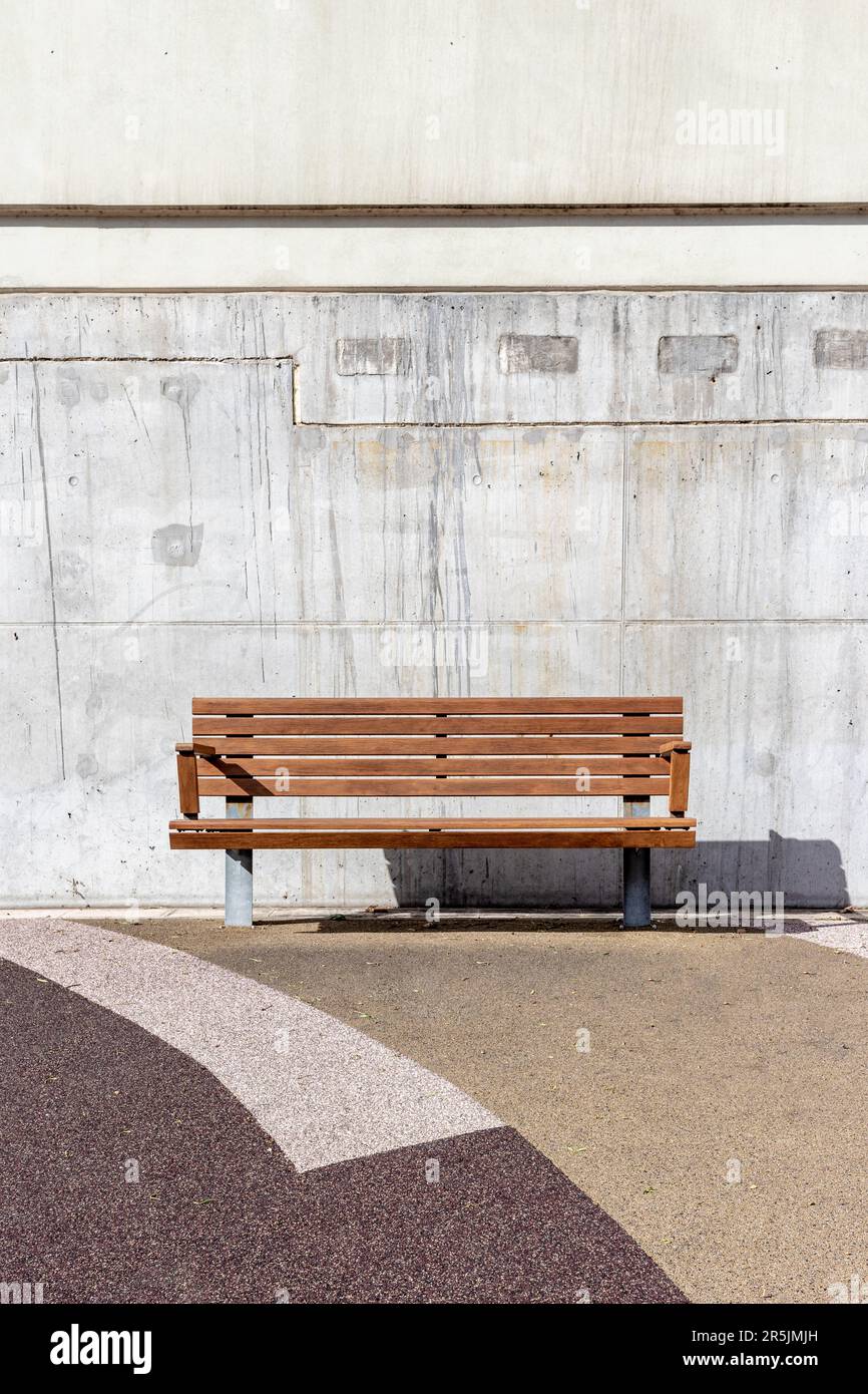 wooden park bench in a concrete park Stock Photo - Alamy