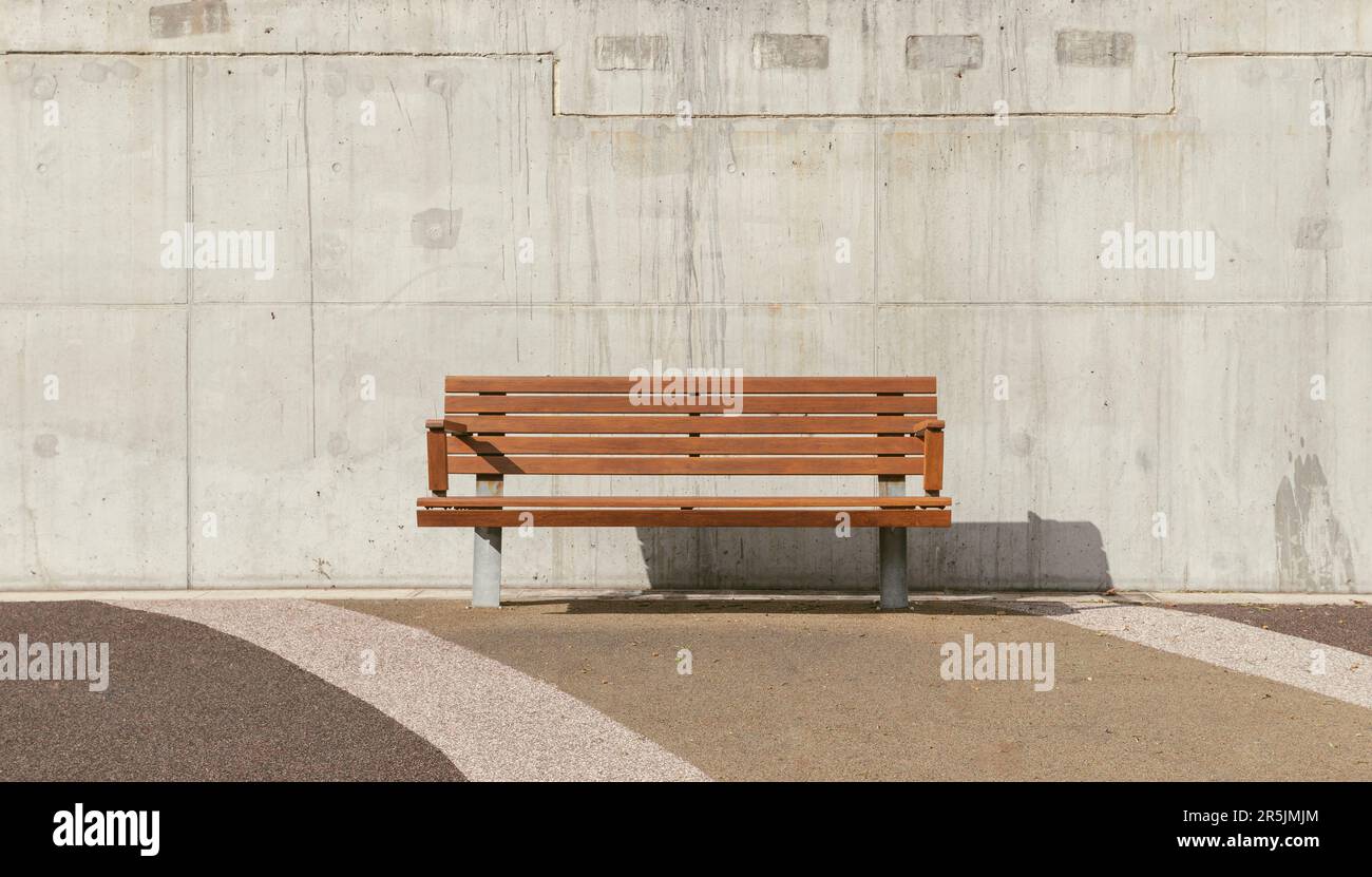 wooden park bench in a concrete park Stock Photo - Alamy