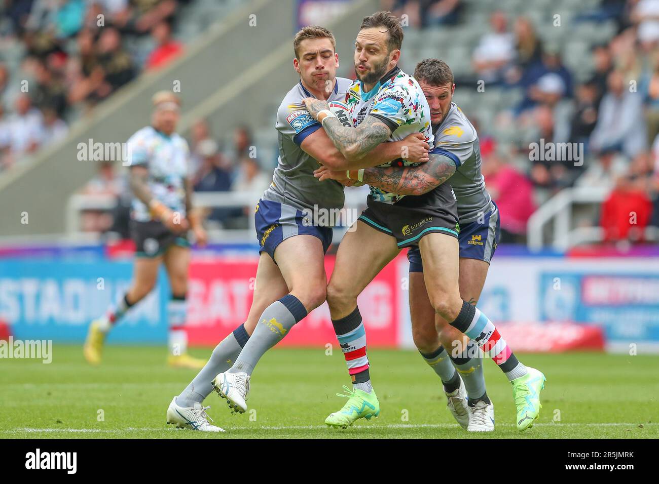 Gareth Obrein #17 of Leigh Leopards is tackled by Jay Pitts #13 of ...