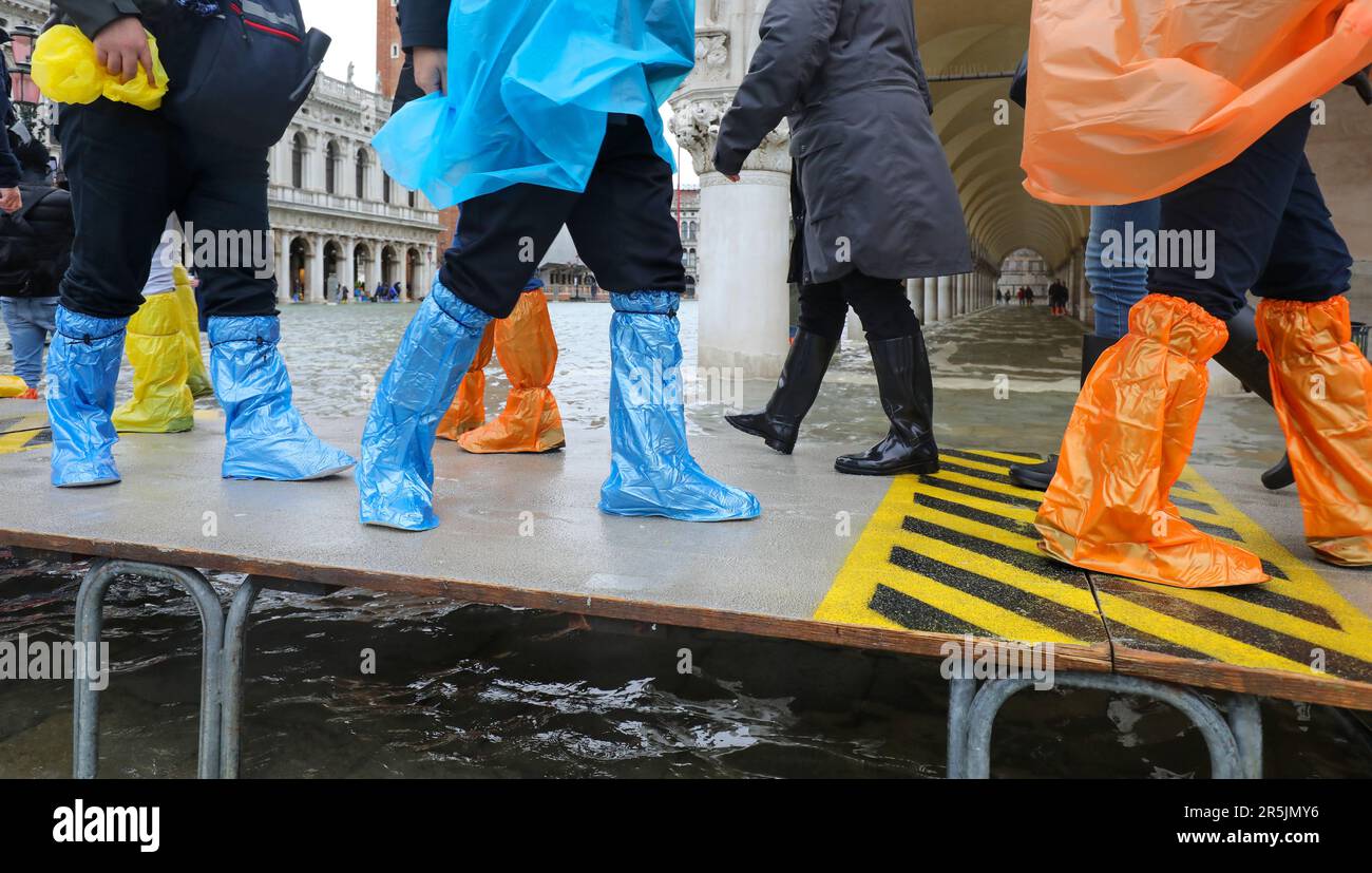 high water in Venice in northern Italy and people walking over the ...