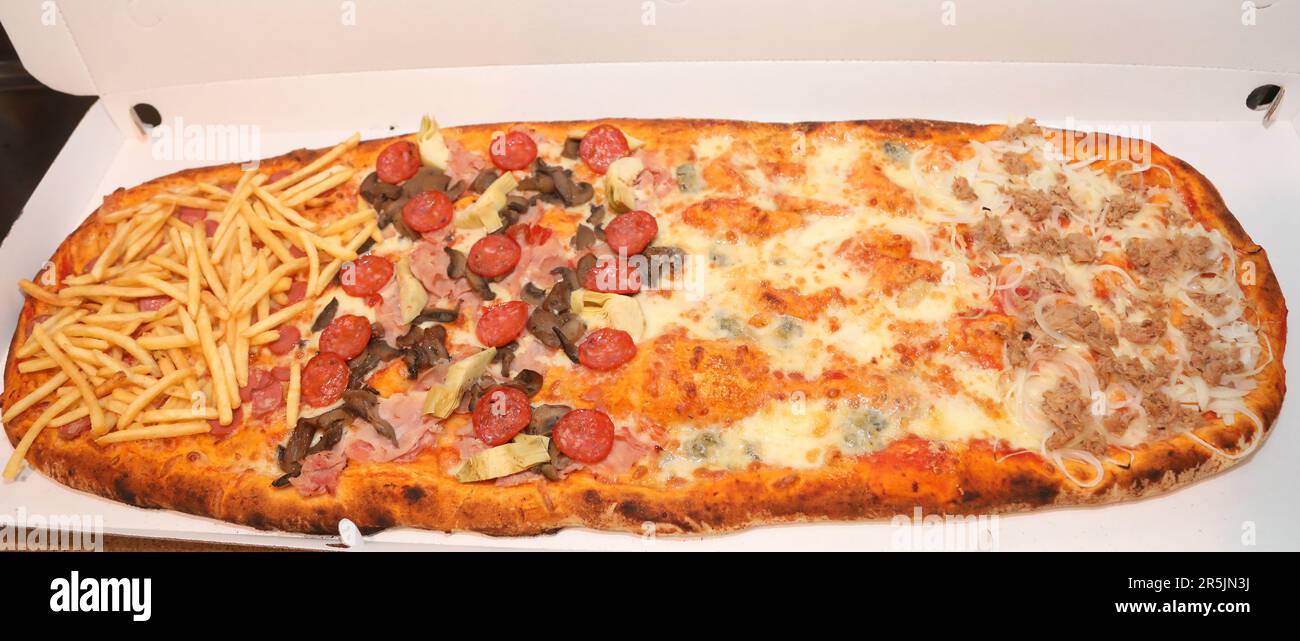huge long pizza with tomato cheese mozzarella spicy salami mushrooms in ...