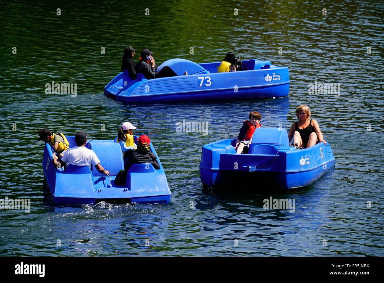 People ride pedalo and rowing boats in the hot weather on the ...