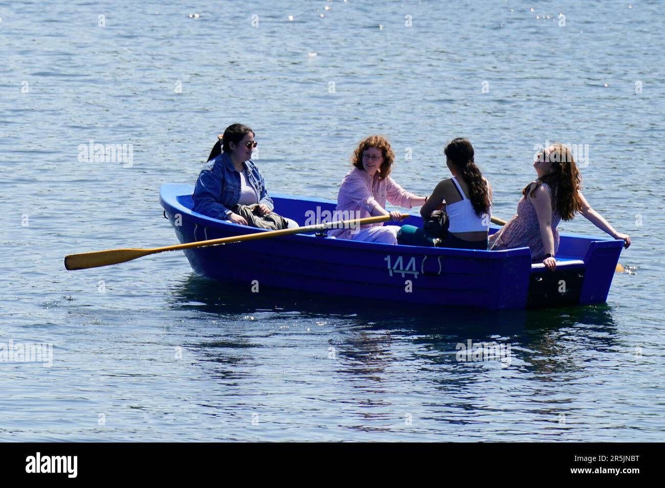 People ride pedalo and rowing boats in the hot weather on the ...