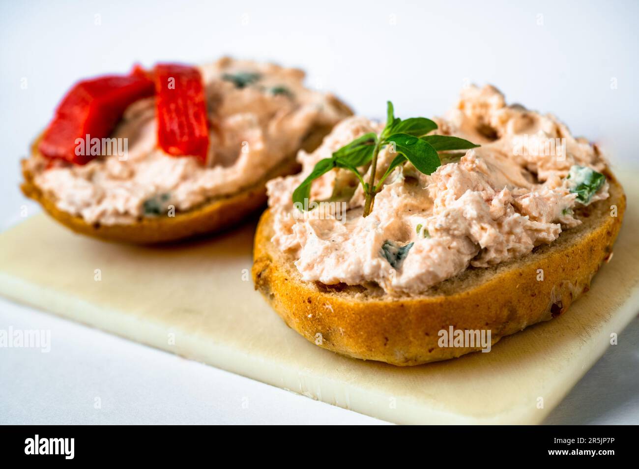 2 canapés with whipped salmon and fresh cheese spread on small kitchen ...