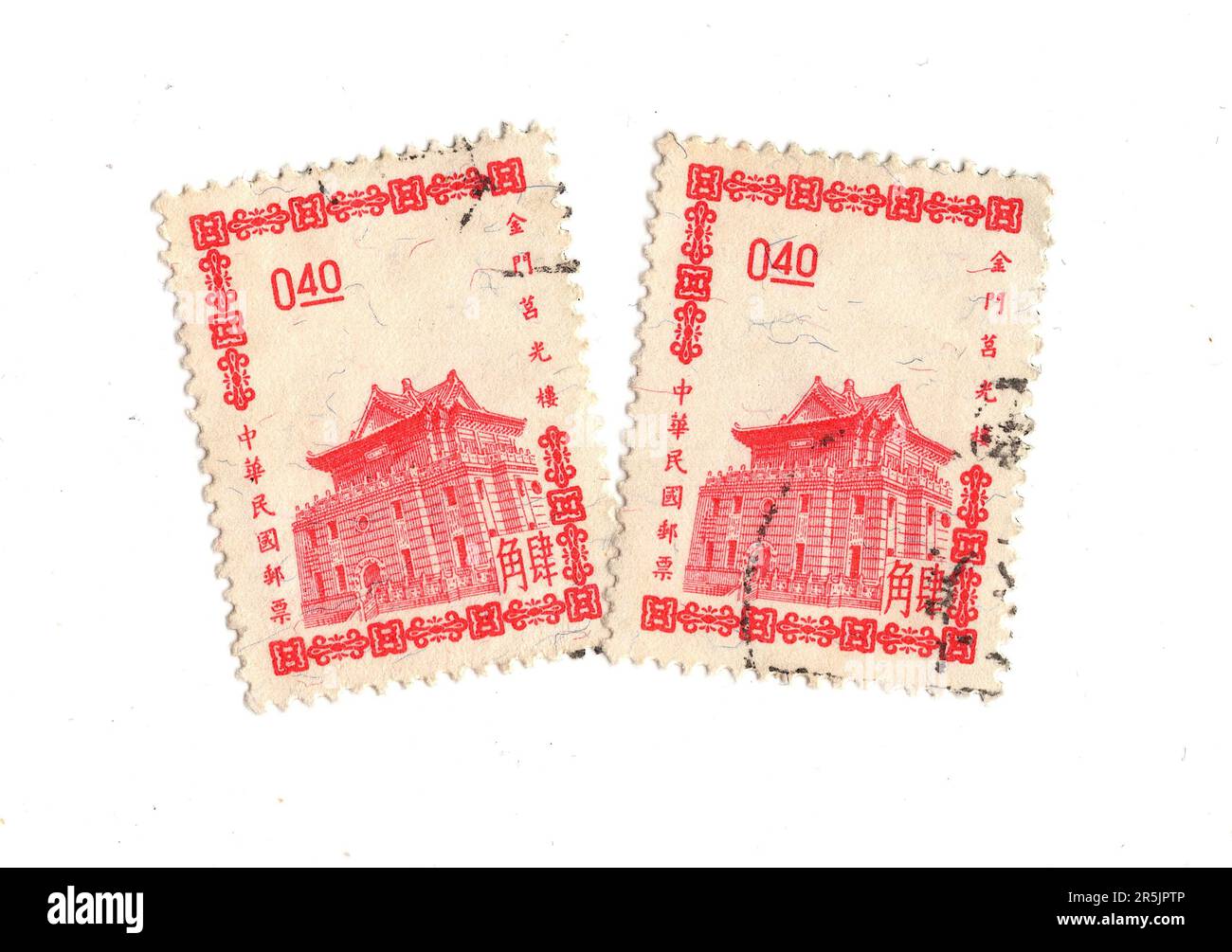 Red vintage postage stamps from China featuring historic buildings isolated on a white ...