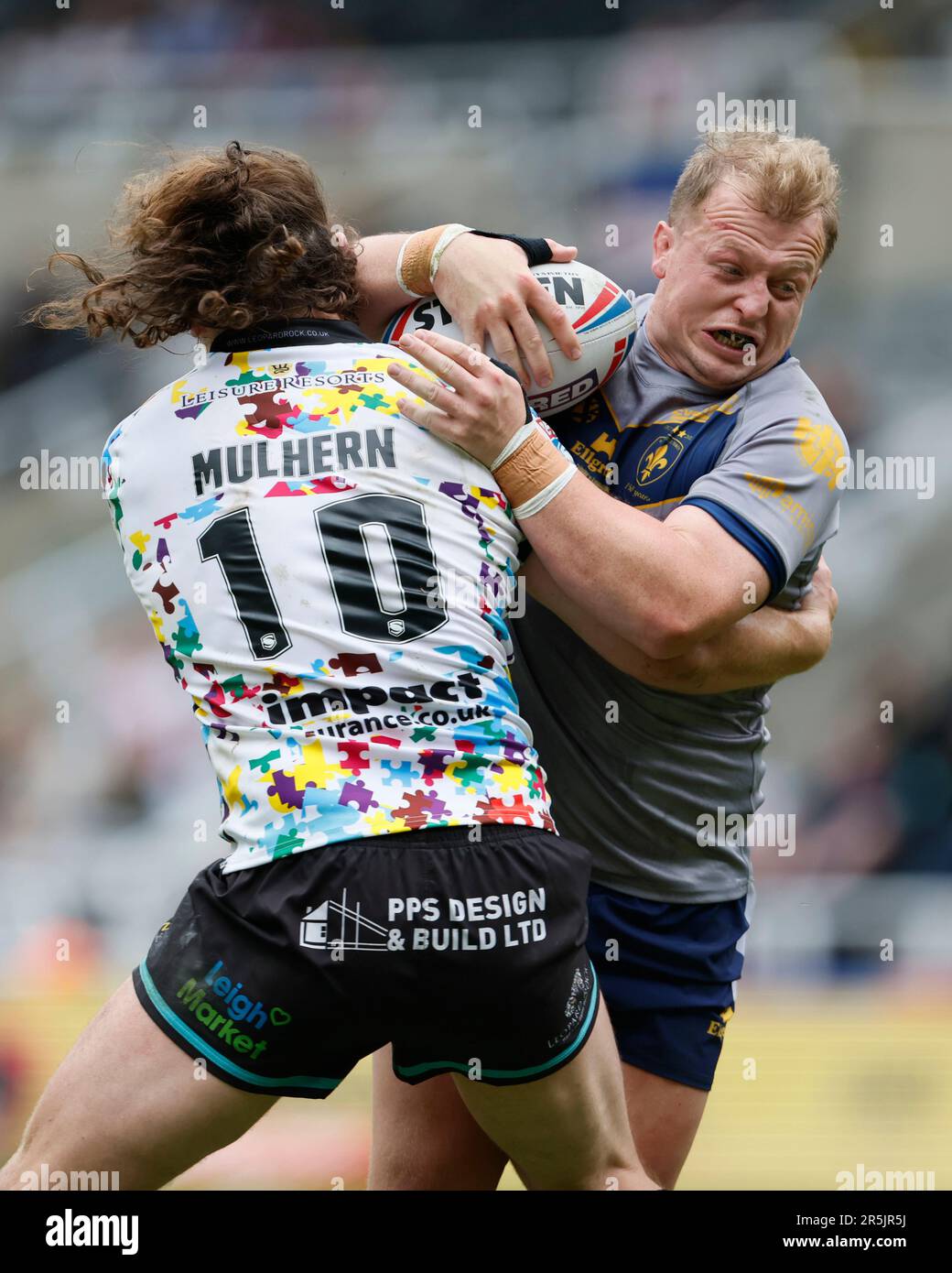 Wakefield Trinity’s Eddie Battye is tackled by Leigh Leopards’ Robbie ...