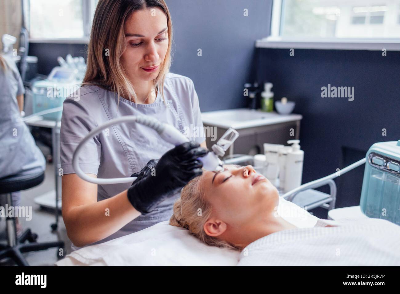 Caucasian woman getting face peeling procedure in a beauty clinic ...