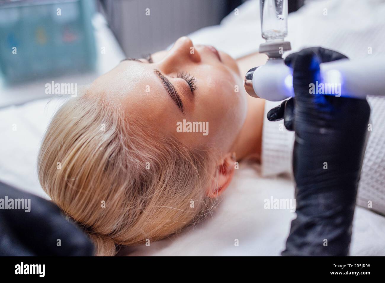 Caucasian woman getting face peeling procedure in a beauty clinic ...