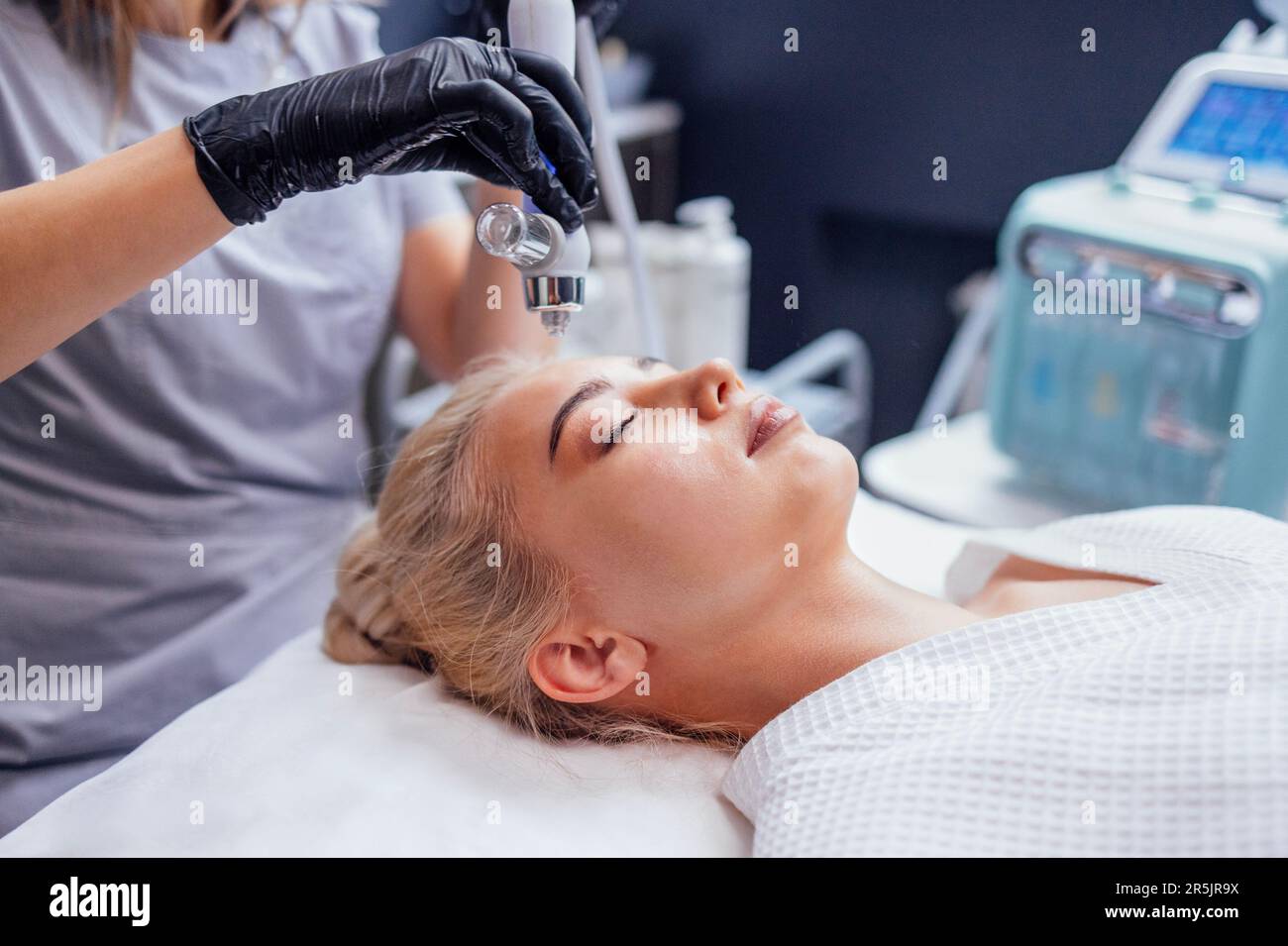 Caucasian woman getting face peeling procedure in a beauty clinic ...