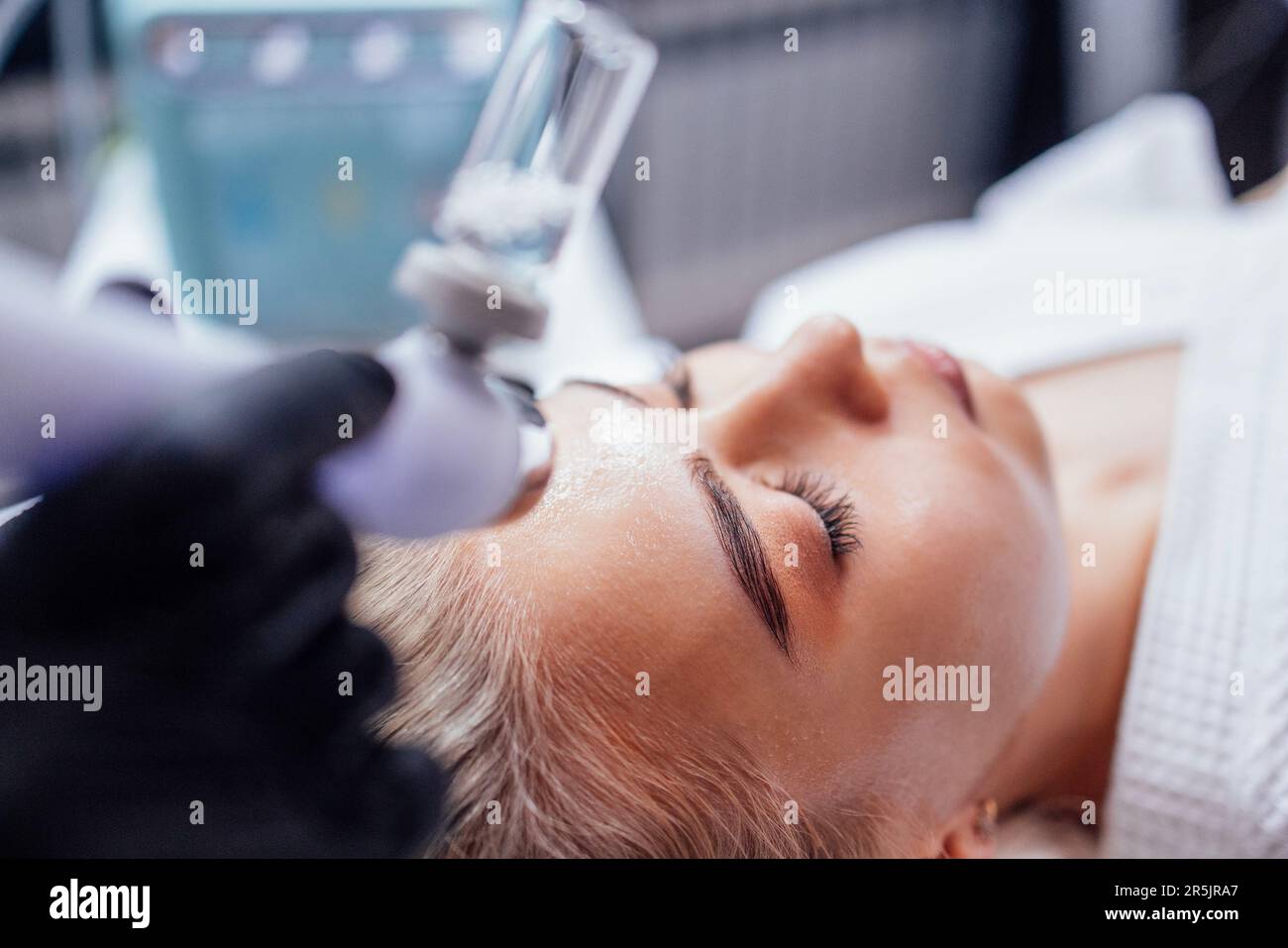 Caucasian woman getting face peeling procedure in a beauty clinic ...