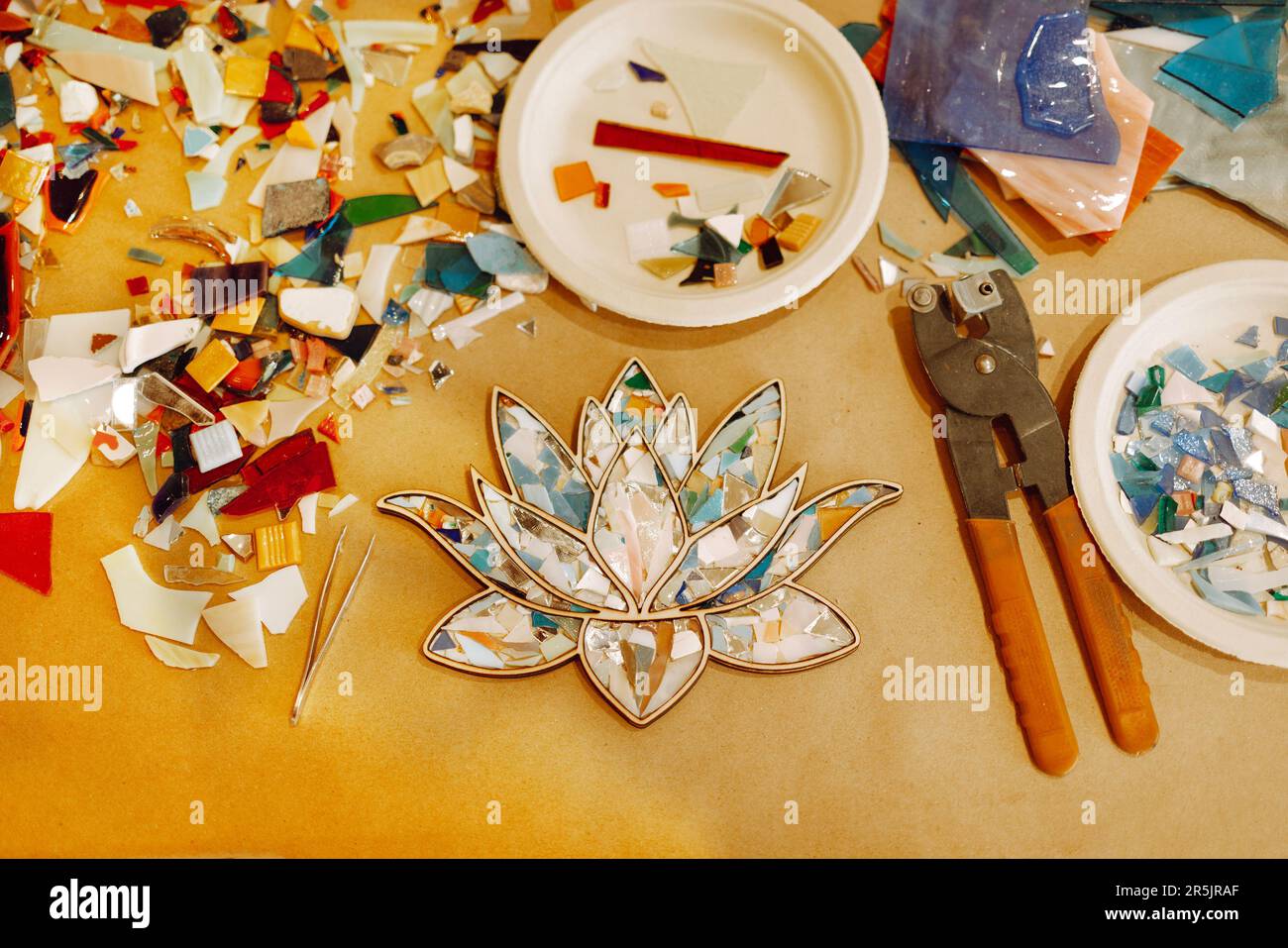 Master class of mosaic art. Closeup of mosaic in shape of lotus flower ...