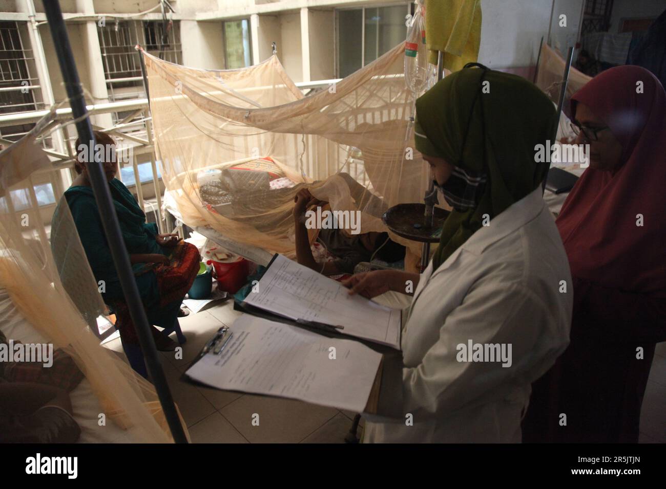Dengue fever patients lying on the floor and on the bed outside the mugda medical hospital ...
