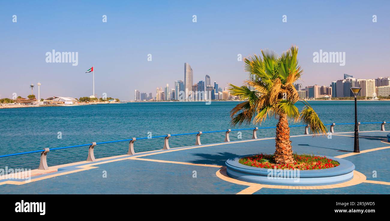 Abu Dhabi with palm trees and skyscrapers. Sunny summer in UAE Stock ...