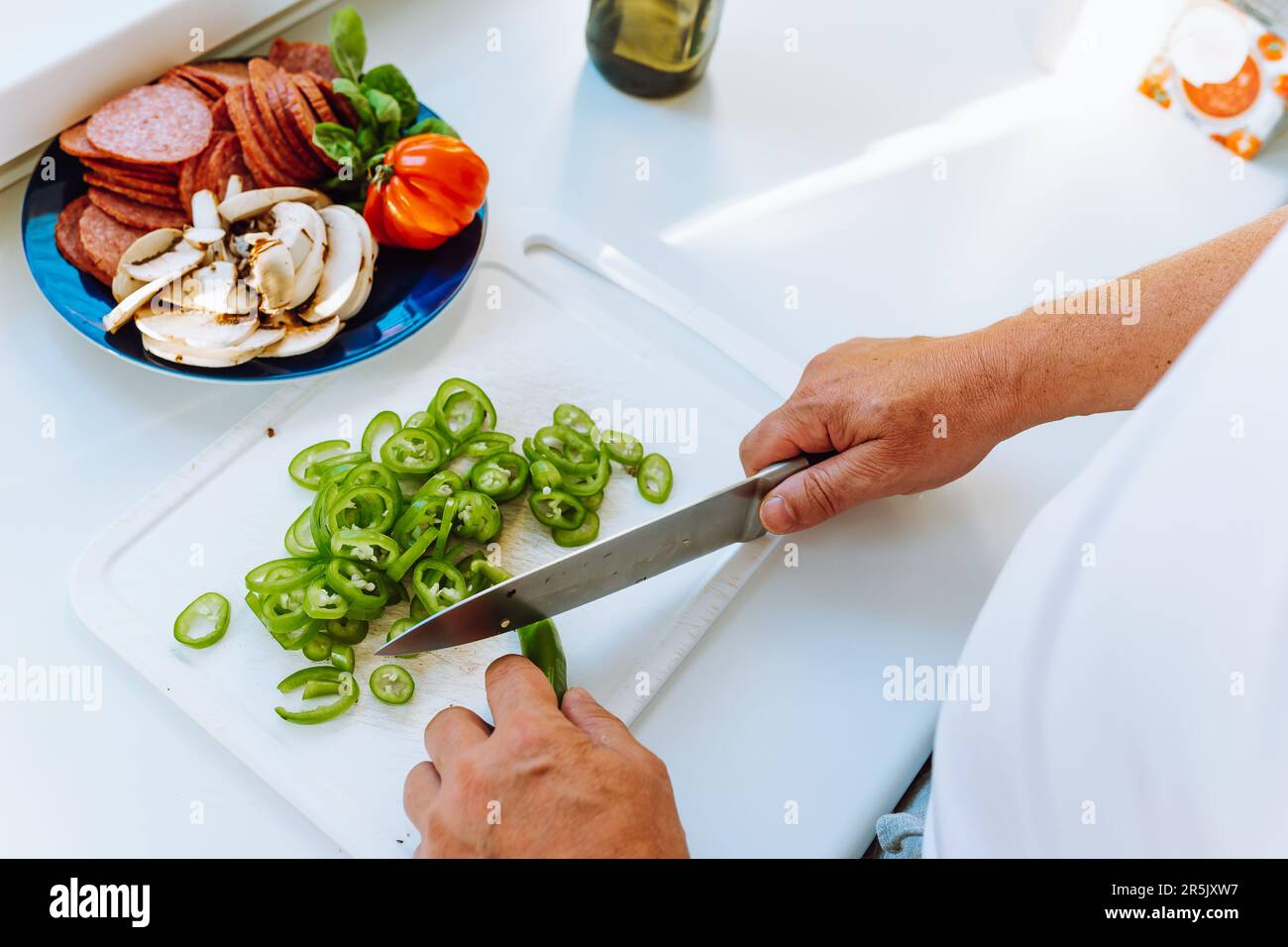 Hands man close-up top view cut pepper into slices Stock Photo - Alamy