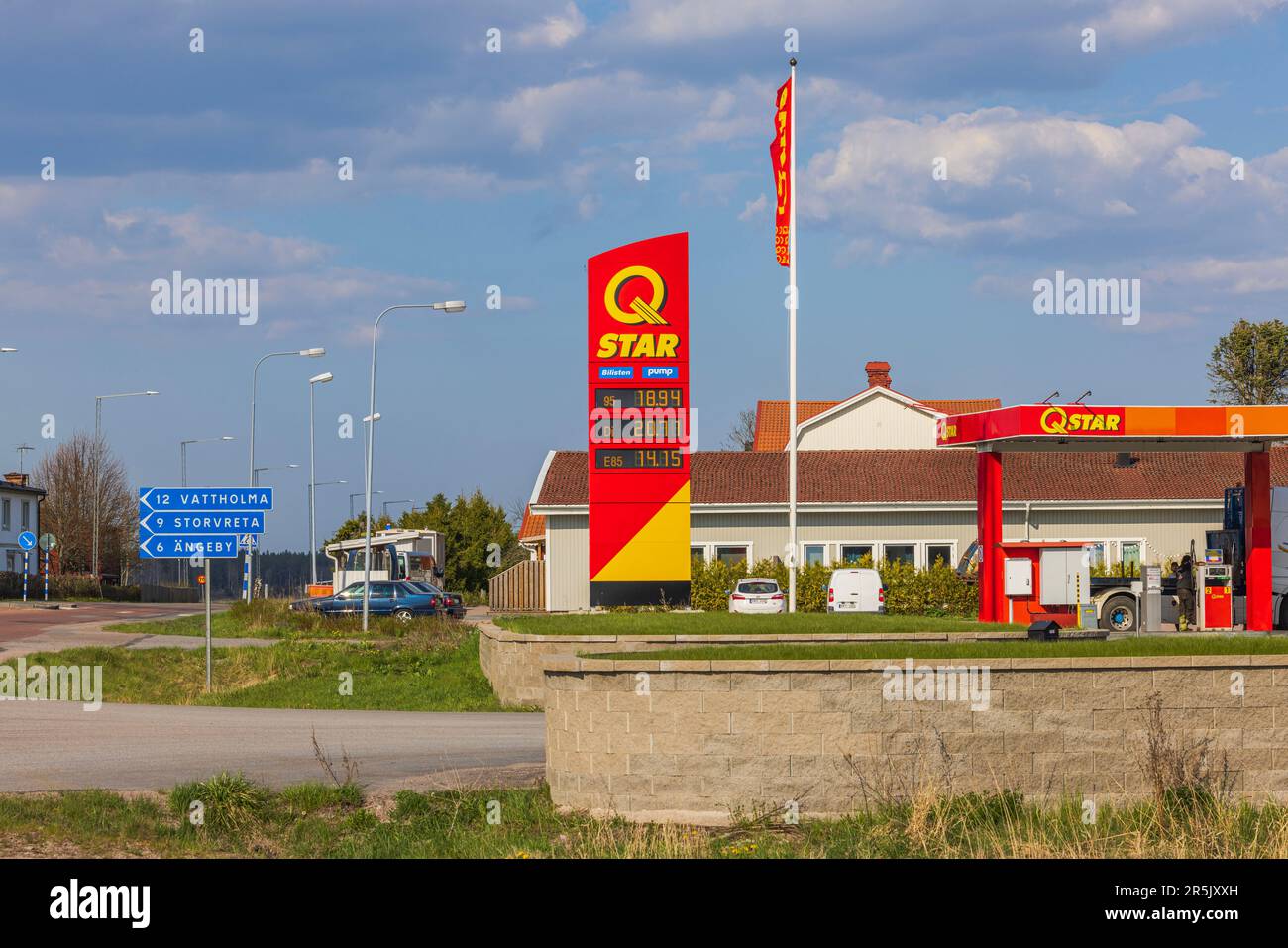 Self service Q star gasoline station on blue sky with white clouds ...