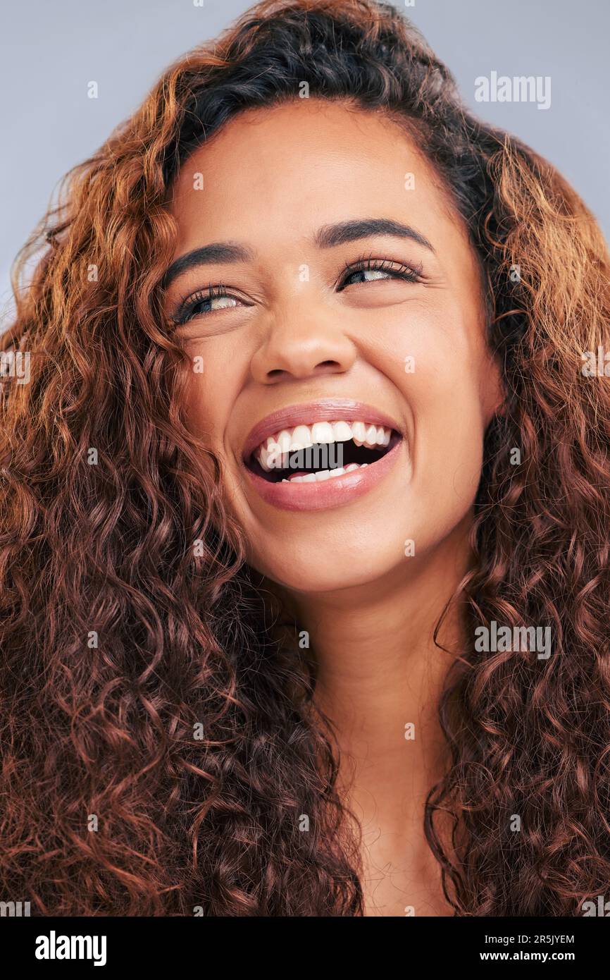 Laughing, curly hair and natural woman in studio with smile and face ...