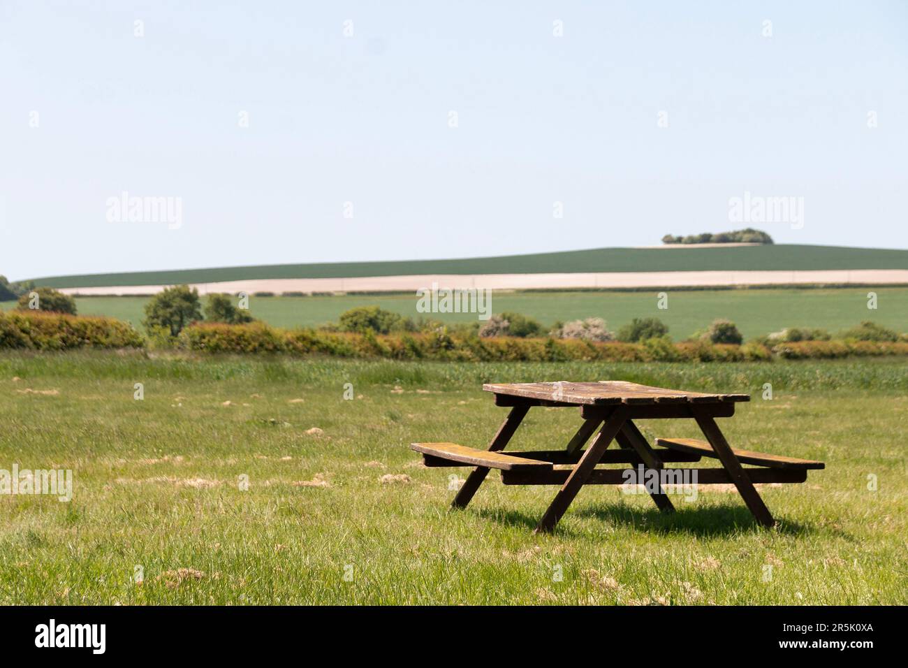 Table and chairs in an open field Stock Photo - Alamy