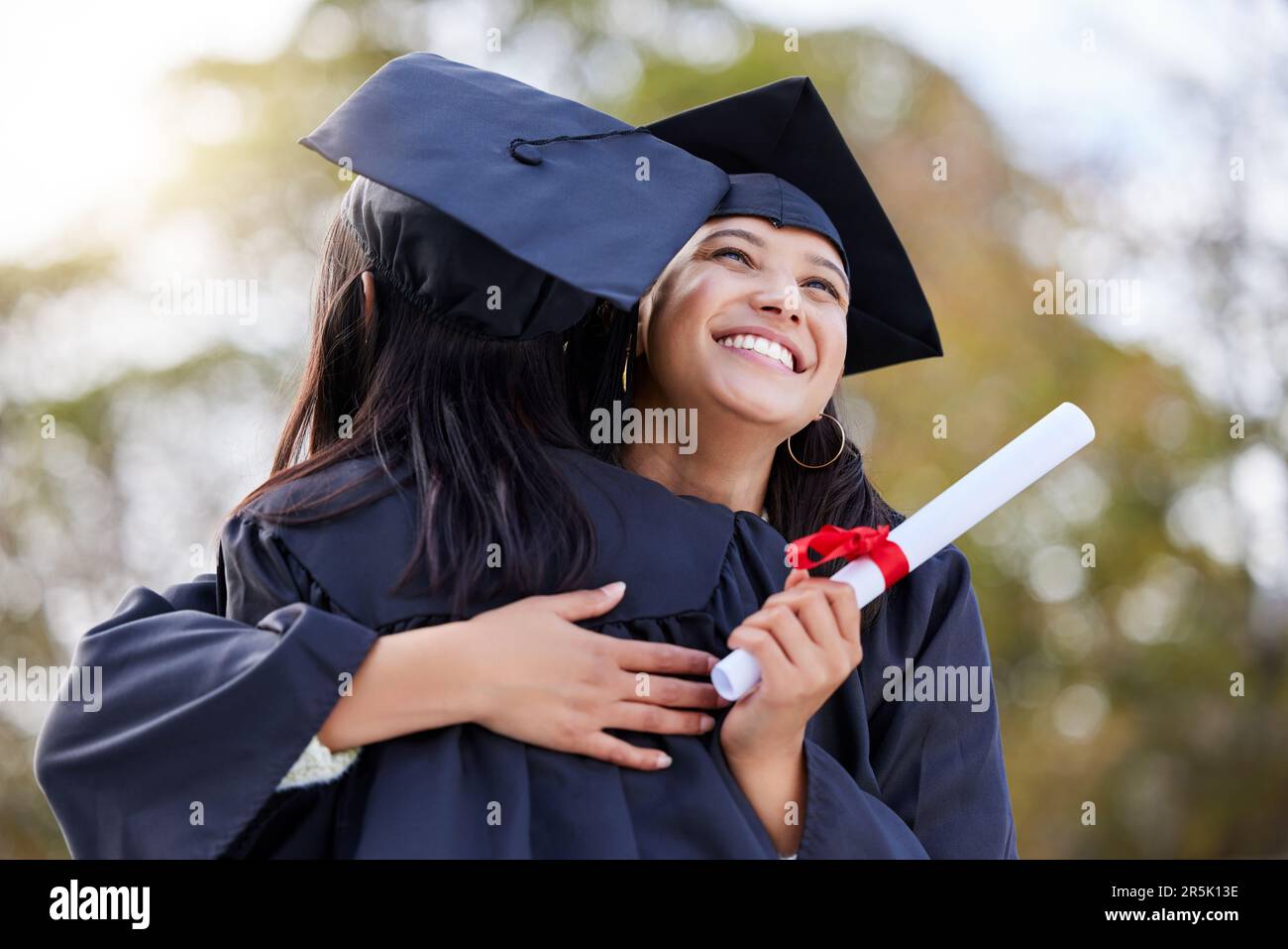 Graduation, education and woman friends hugging at a university event ...