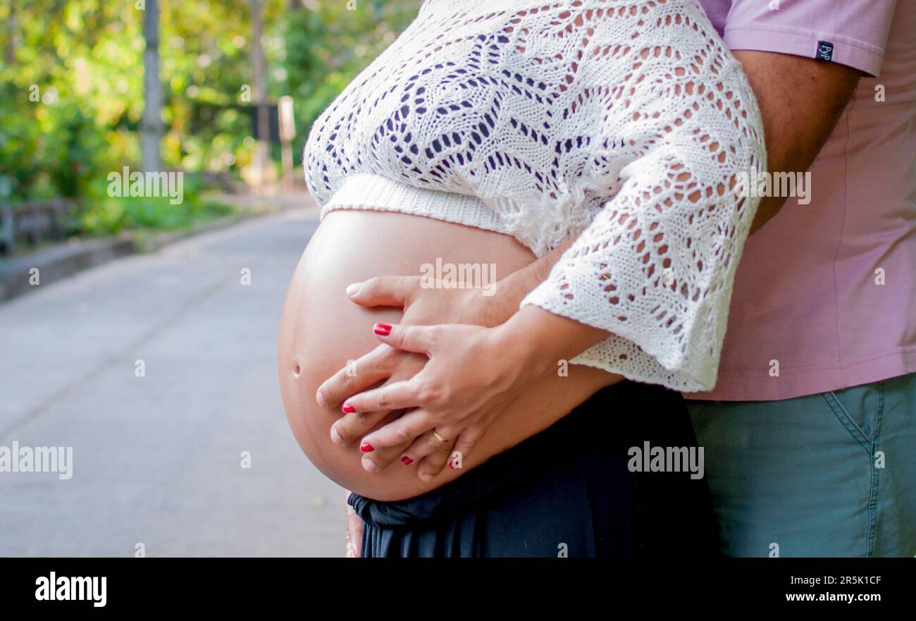 Photo of pregnant belly. Hands on pregnant belly Stock Photo - Alamy