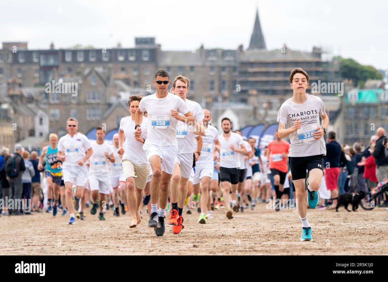 Runners, wearing white, compete in the annual Chariots of Fire race ...