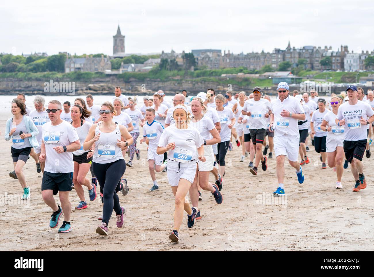 Runners, wearing white, compete in the annual Chariots of Fire race ...