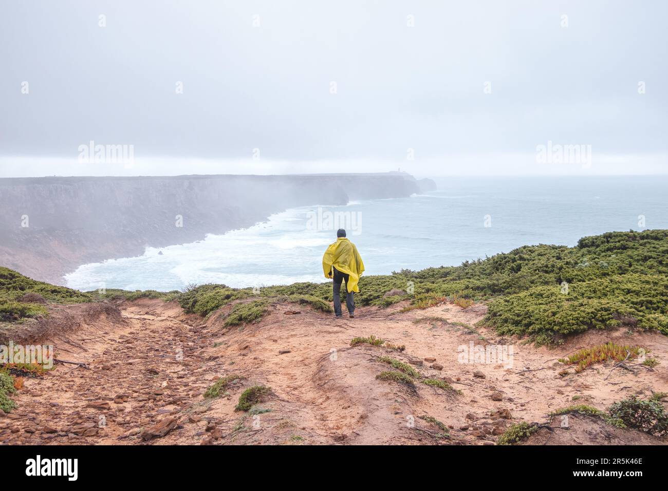 Wandering in heavy rain and wearing a raincoat along the Fisherman ...