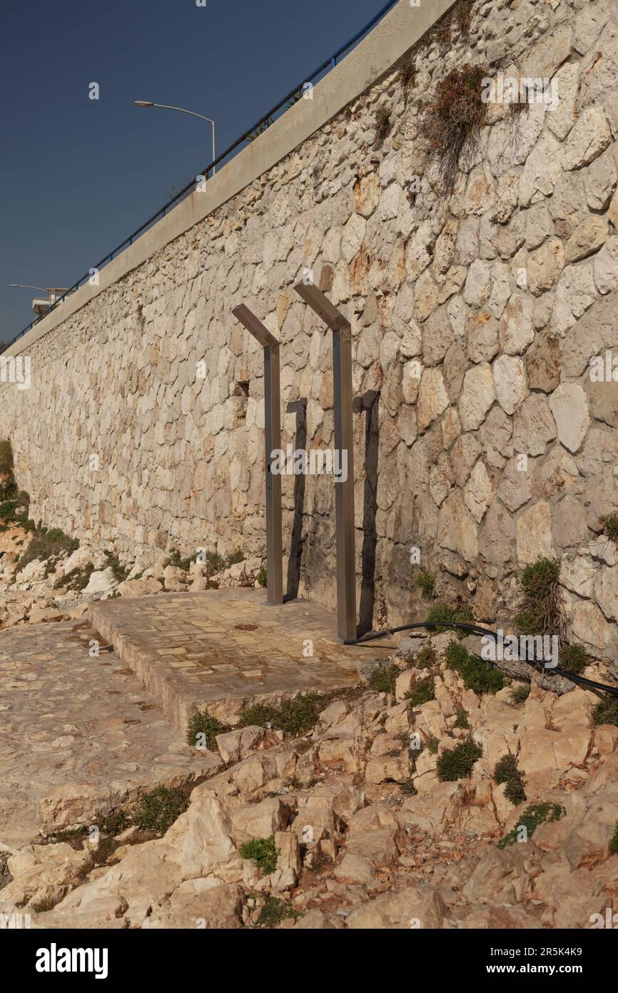 NICE, FRANCE - CIRCA MARCH, 2023: Empty beach shower on a stone beach ...