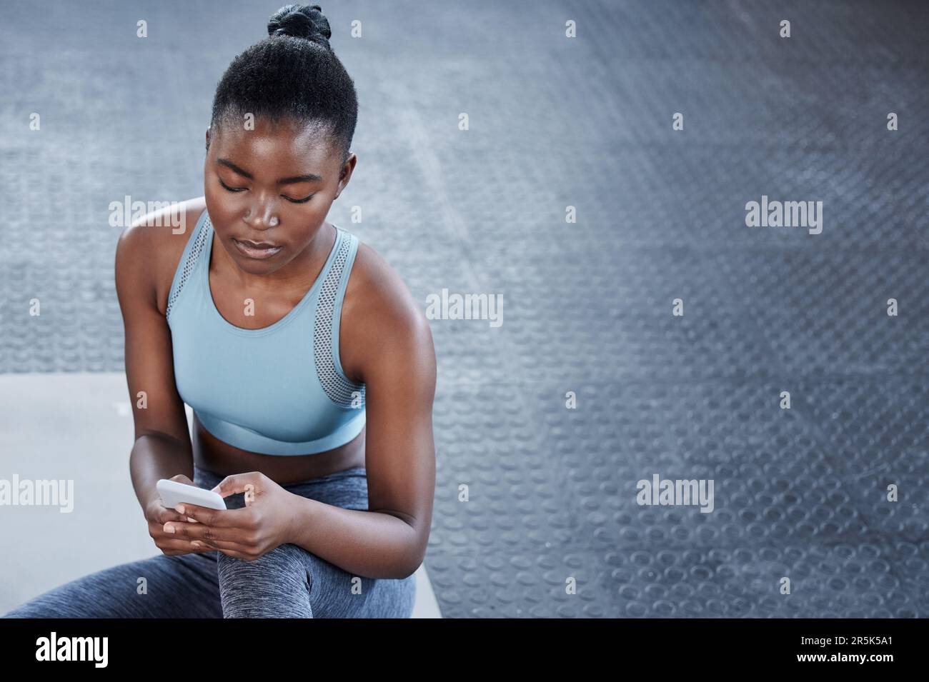 Smartphone, relax or black woman in gym on social media on fitness ...