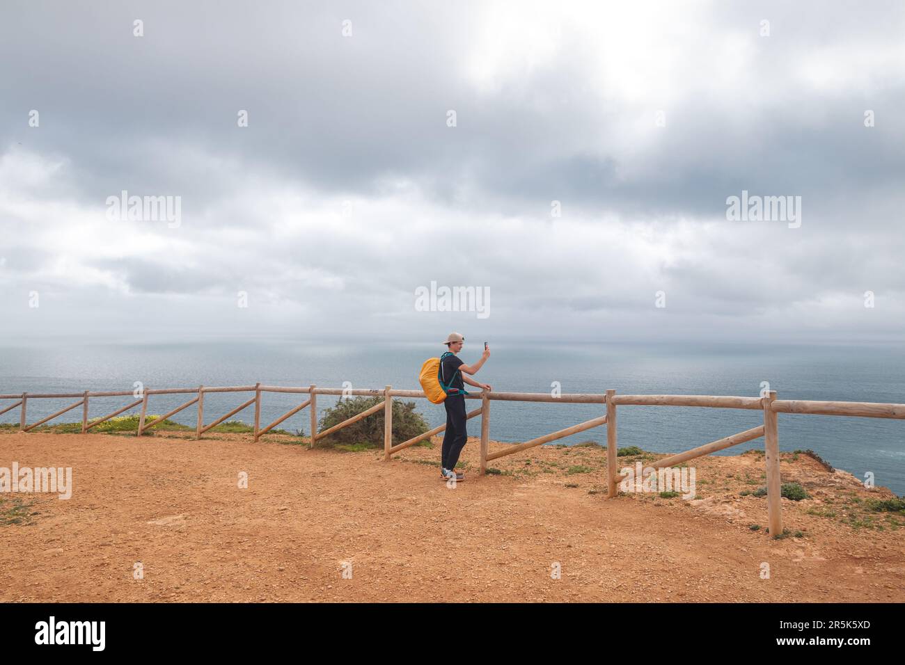 Traveller takes a picture on his mobile phone at the top of Atalaia ...