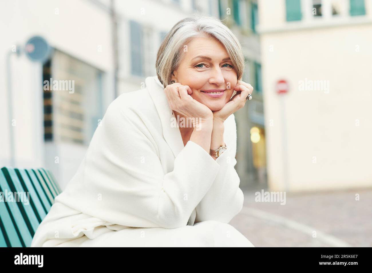 Outdoor portrait of beautiful and elegant middle age 55 - 60 year old ...