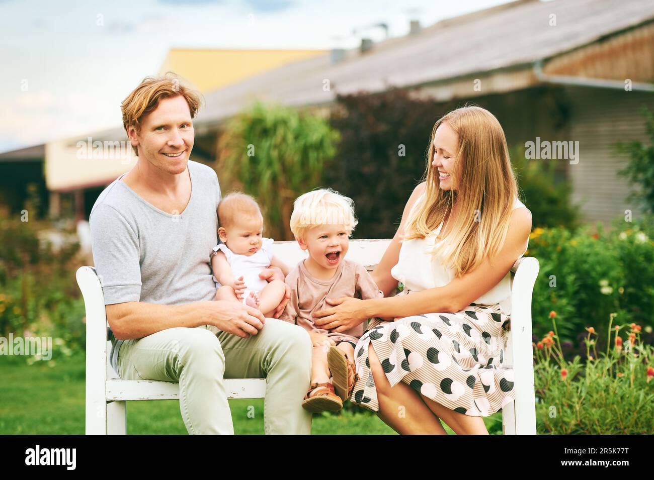 Outdoor portrait of happy young family with children, baby girl and ...