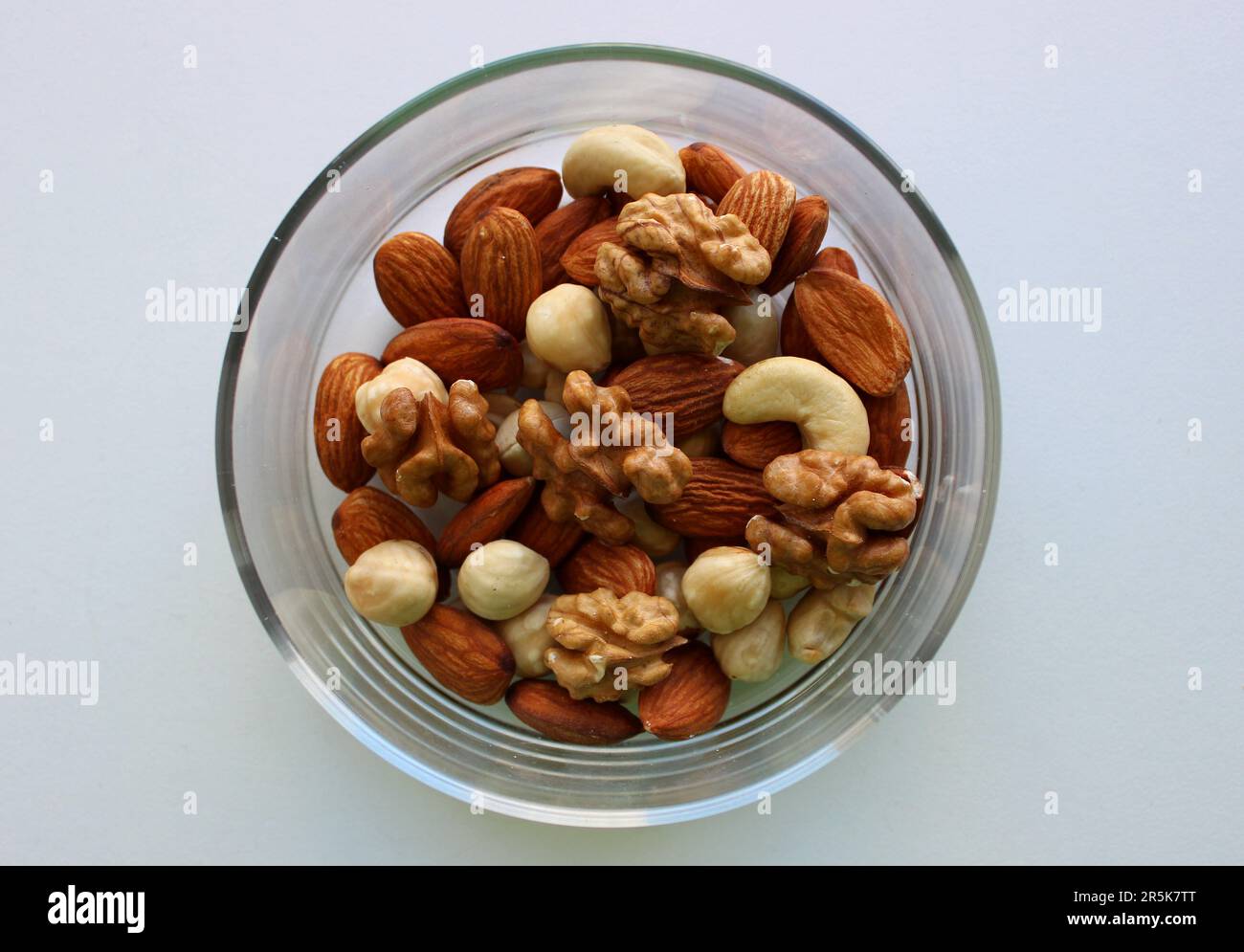 Glass Plate With Mix Of Different Shelled Nuts On White Surface Top ...