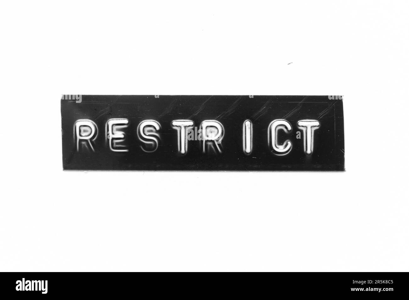 Black color banner that have embossed letter with word restrict on ...