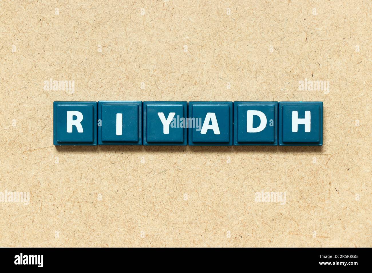 Tile alphabet letter in word riyadh on wood background Stock Photo - Alamy