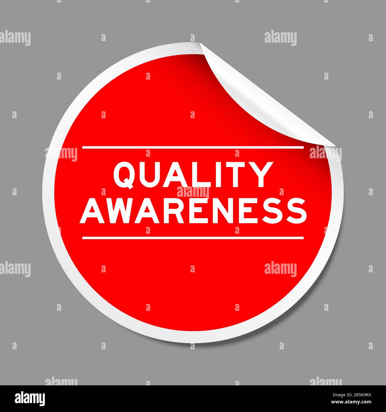 Red color peel sticker label with word quality awareness on gray ...