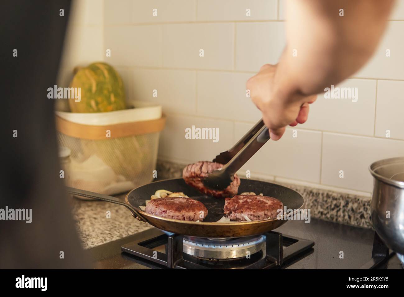 wellington buger cooking process by son and father Stock Photo - Alamy