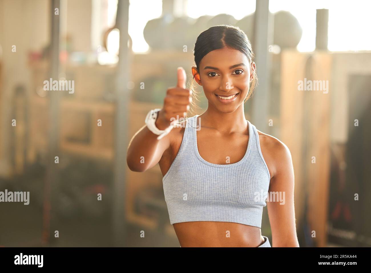 Gym, portrait or Indian woman with thumbs up in fitness training with ...