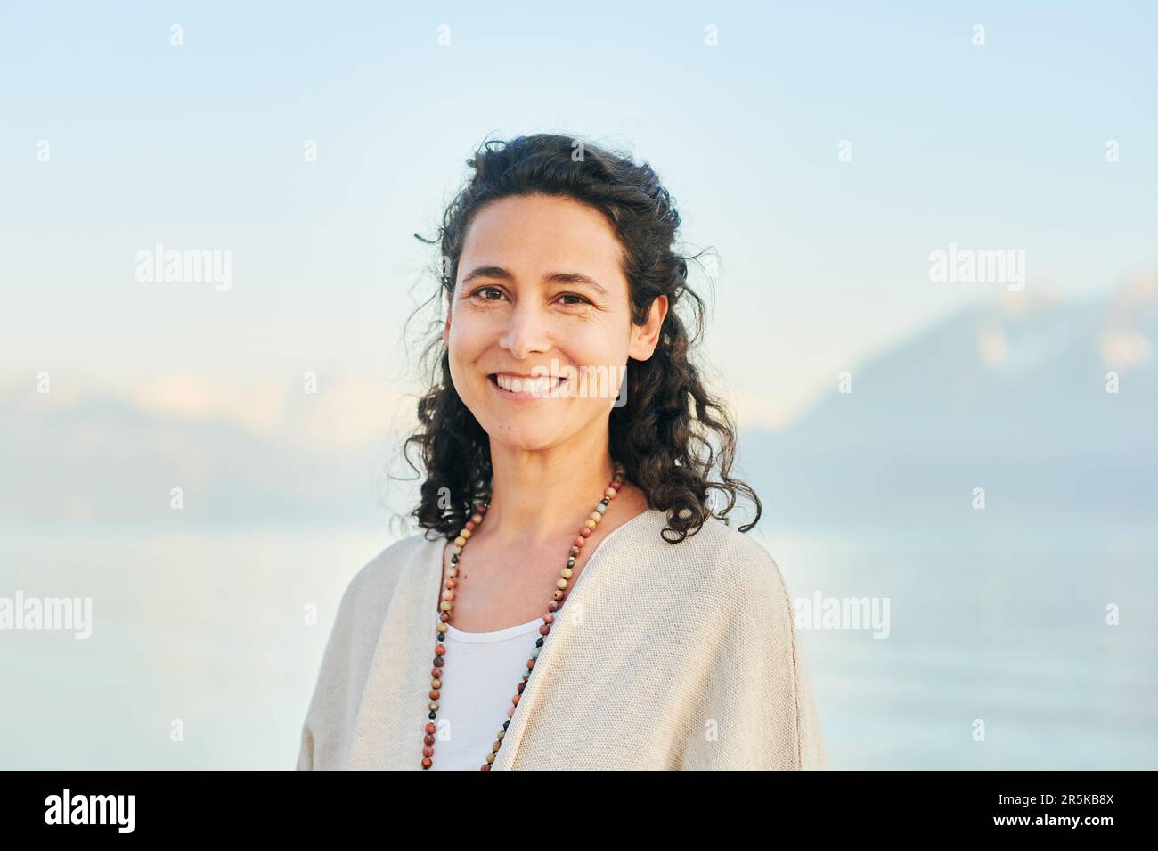 Outdoor portrait of beautiful middle age hispanic woman enjoying nice ...