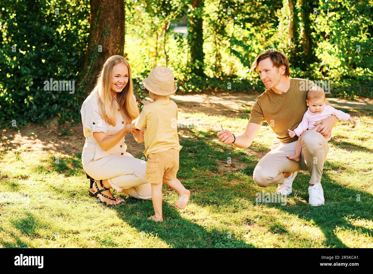 Outdoor portrait of happy family having fun in summer park, young ...