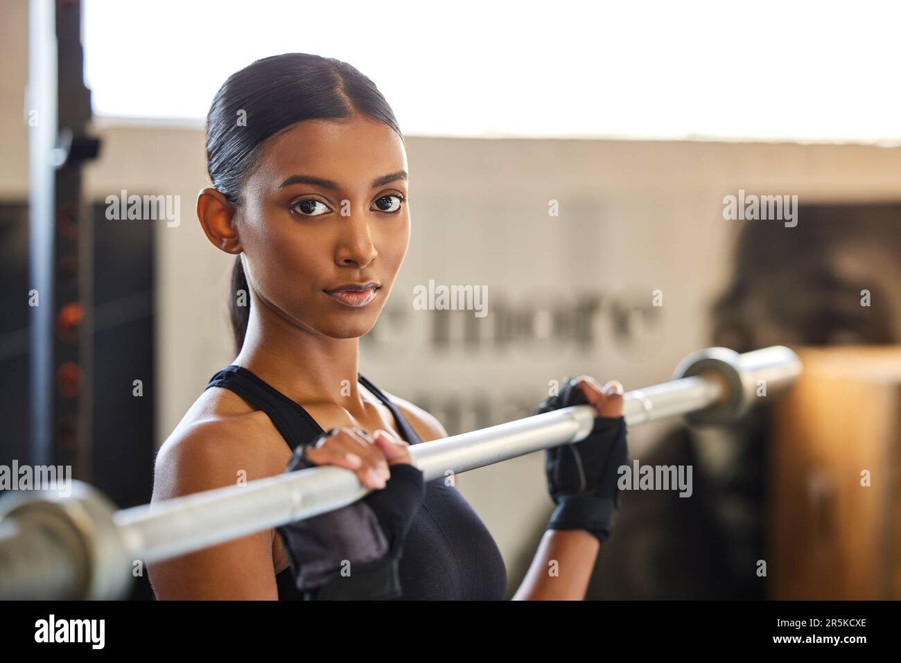 Portrait, Indian woman or bodybuilder with barbell in fitness training ...